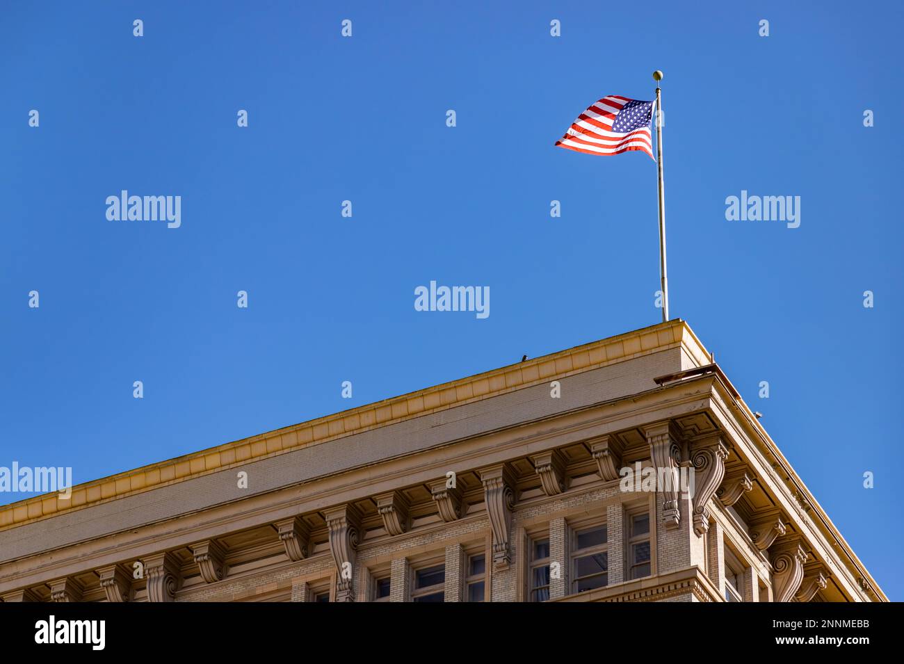 A picture of the American flag atop a building in Downtown Los Angeles ...