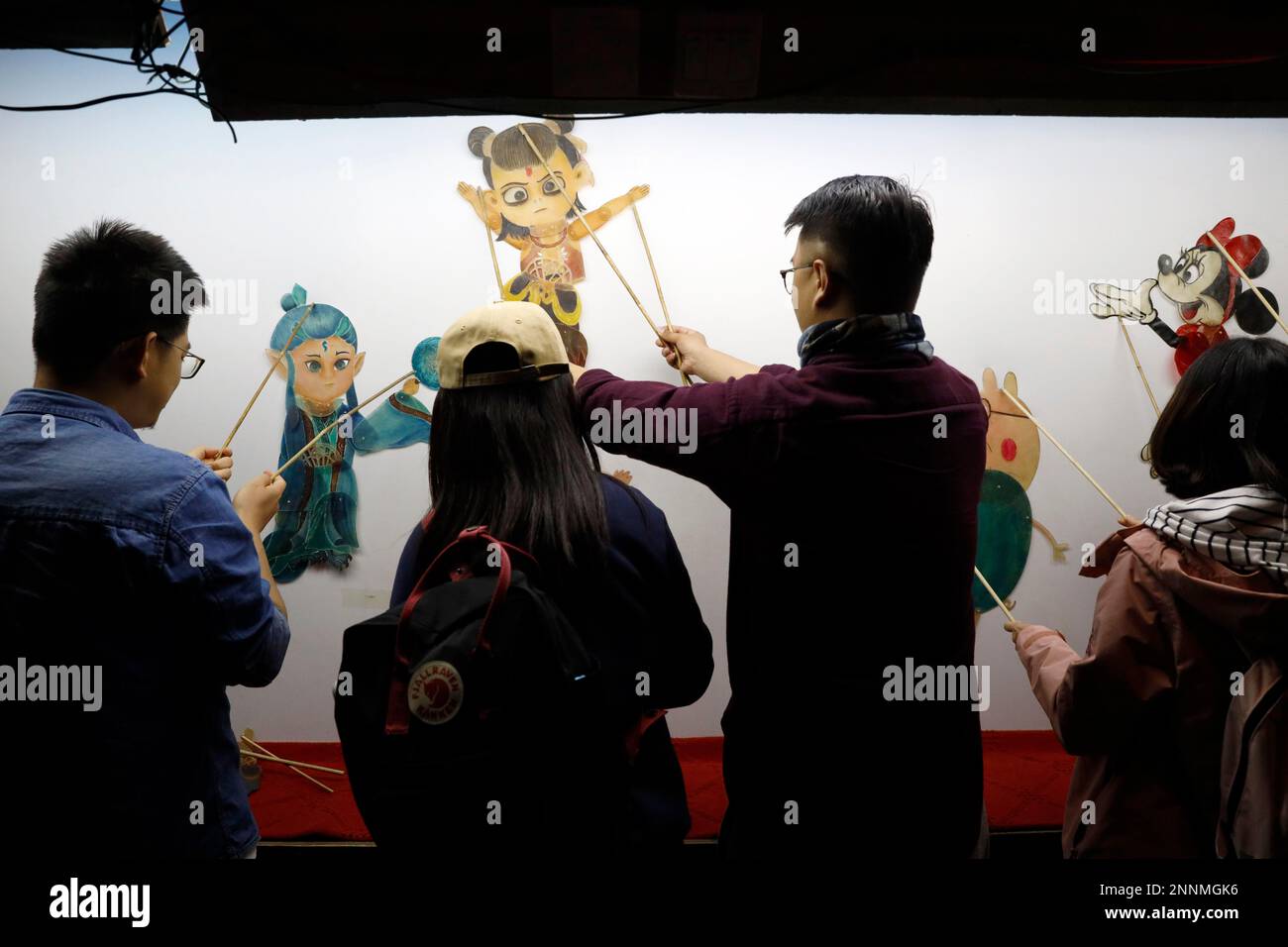 The tourists are making and playing the traditional Chinese shadow ...