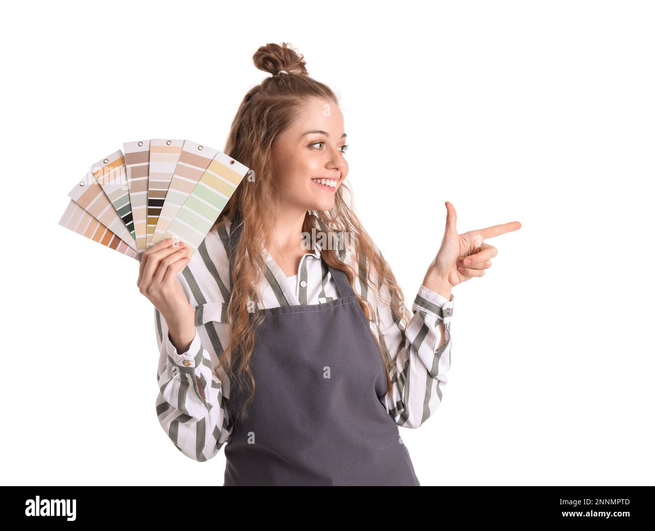 Female artist with paint color palettes pointing at something on white ...