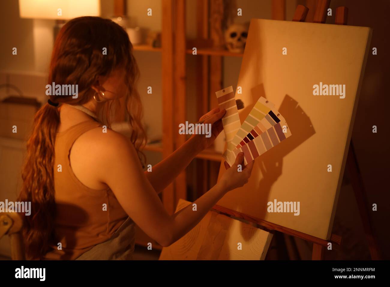 Female artist with color palettes drawing in workshop Stock Photo - Alamy