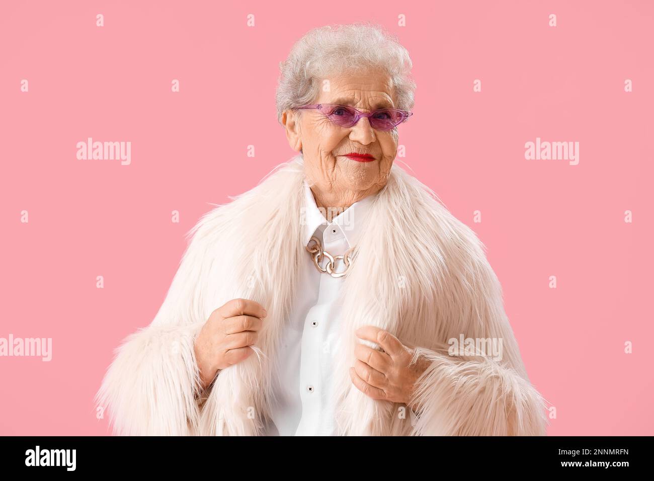 Old woman in pink coat hi-res stock photography and images - Alamy