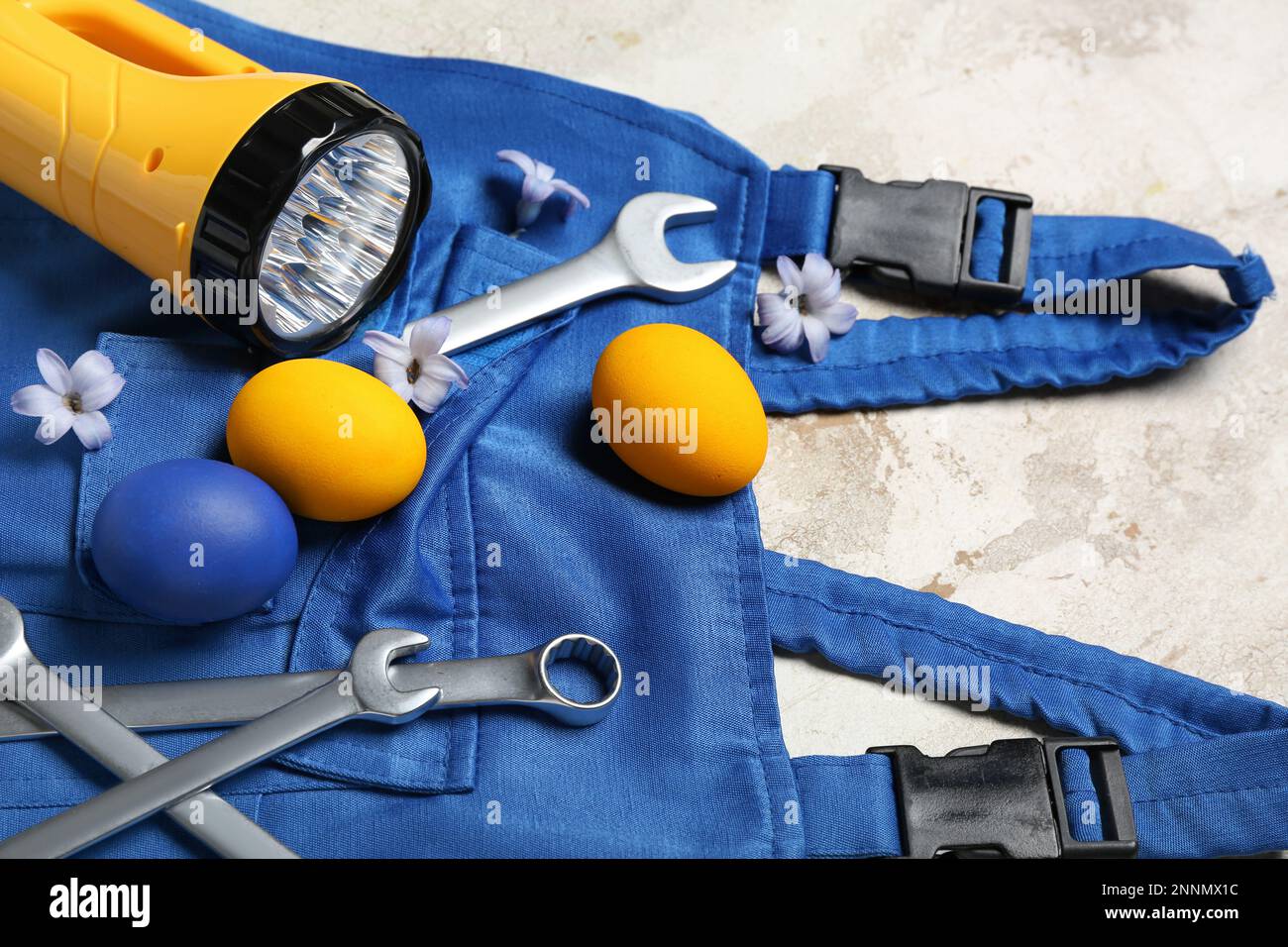 Plumber's uniform with tools, Easter eggs and flowers on grunge ...