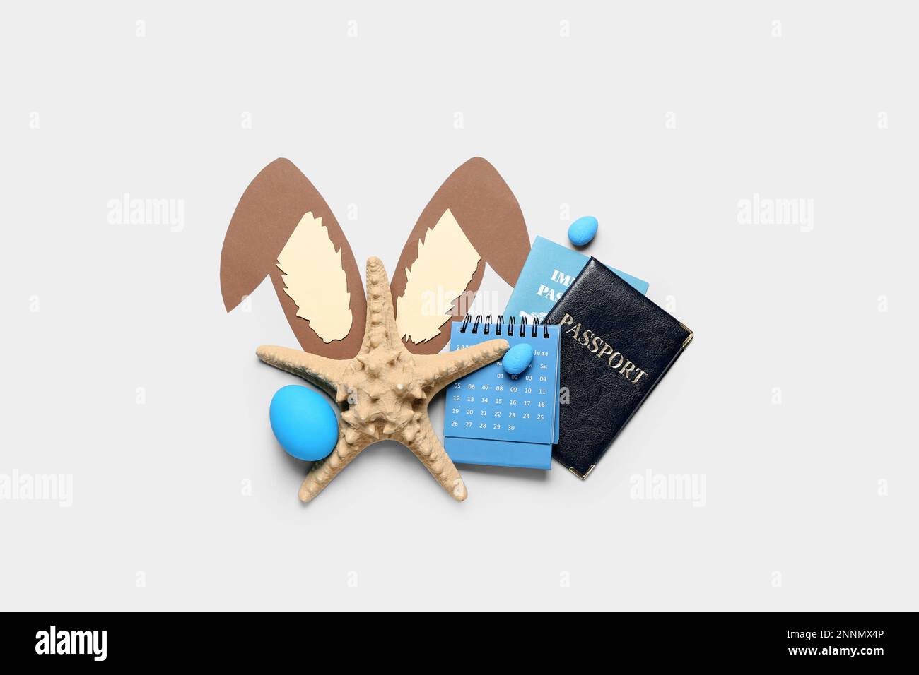 Starfish with paper bunny ears, Easter eggs, calendar and passports on ...