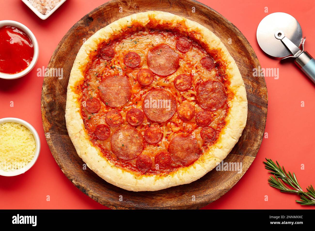 Board with delicious pepperoni pizza and cutter on red background Stock ...