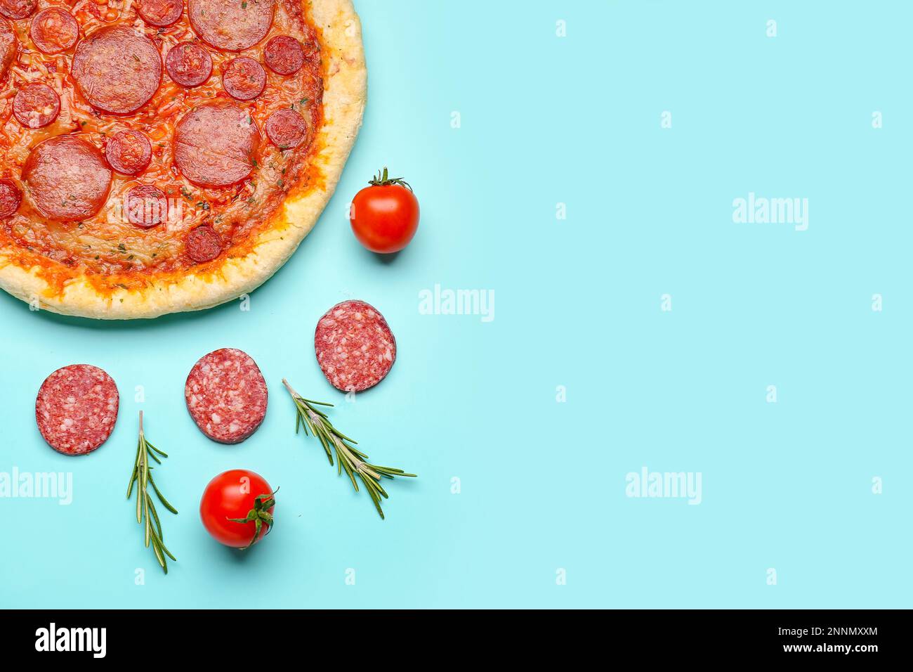 Composition with delicious pepperoni pizza and ingredients on turquoise ...