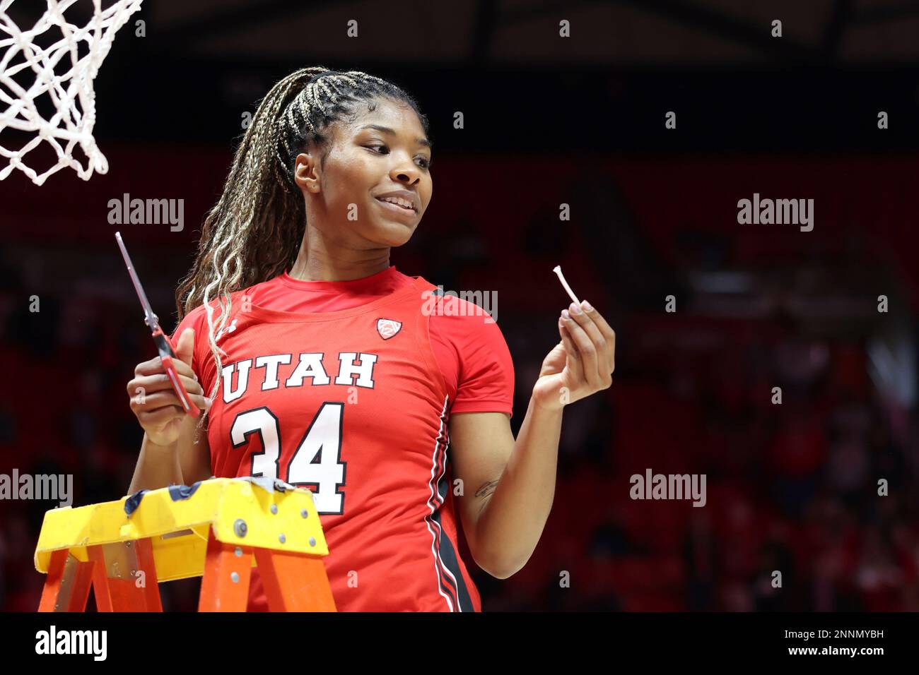 Utah forward Dasia Young (34) hold a piece of the net as co-champions ...