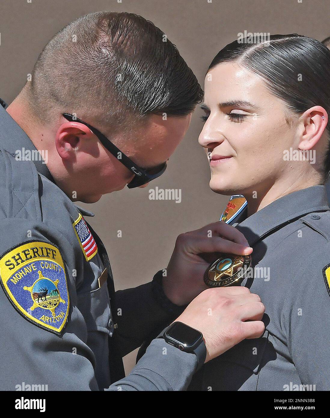 Mohave County Sheriff's Office recruit April Long (right) has her badge ...