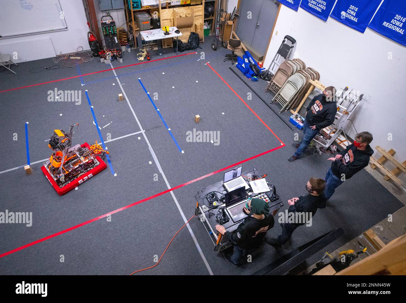 The FIRST Robotics Competition Team 525 members watch as their robot runs an obstacle course ...