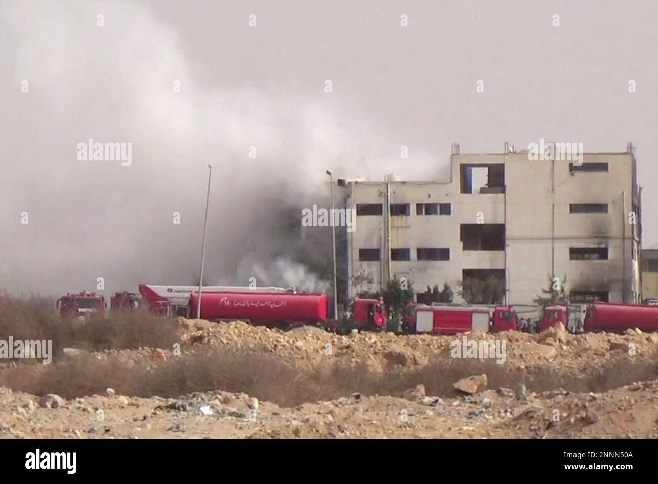 In this image from video, smoke from a fatal fire rises from a garment factory in Obour, Egypt ...