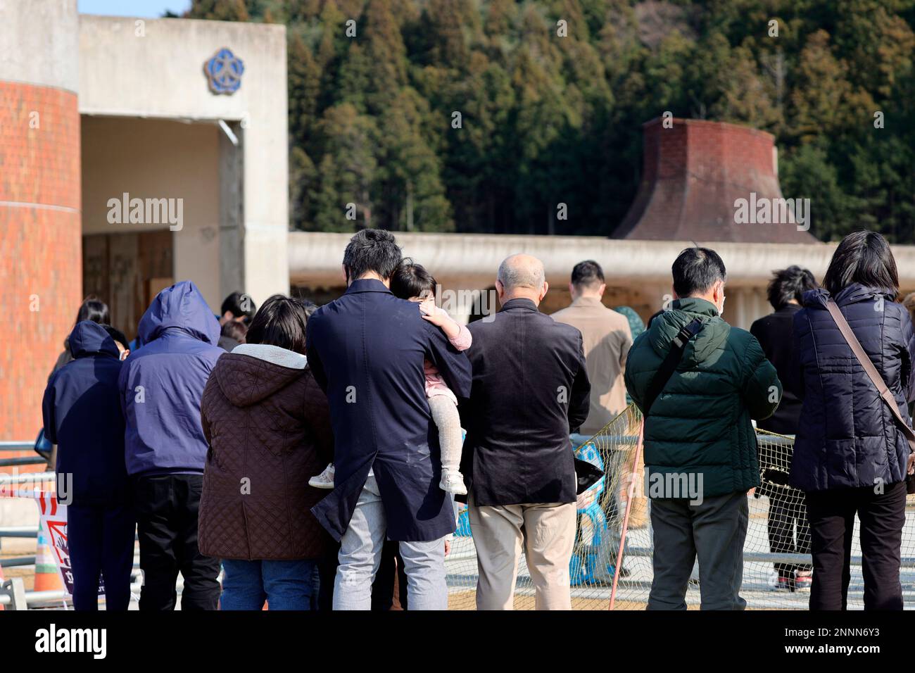 People observe a moment of silence for the victims of the Great East ...