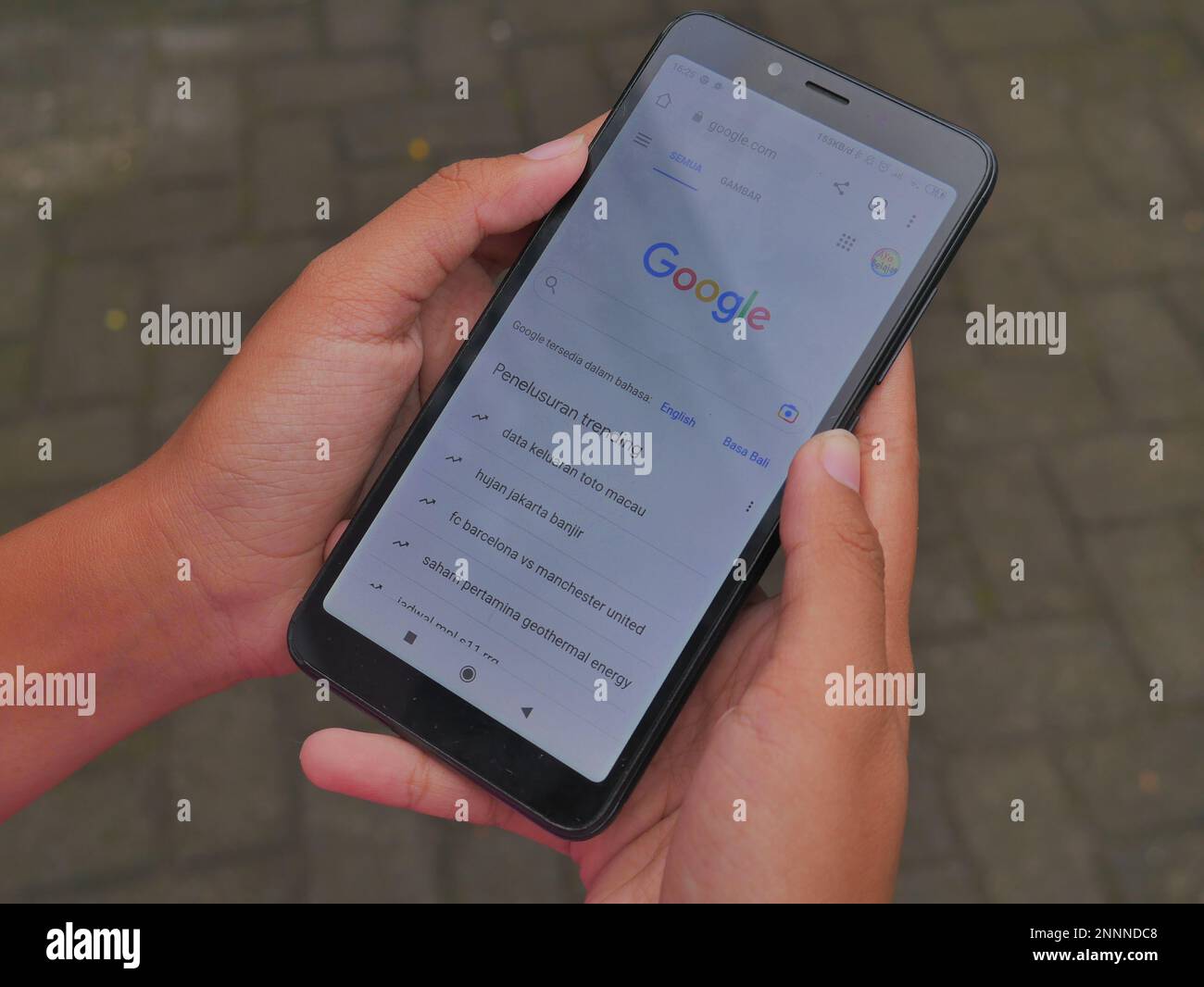 close up of hand holding smartphone opening google search engine Stock ...