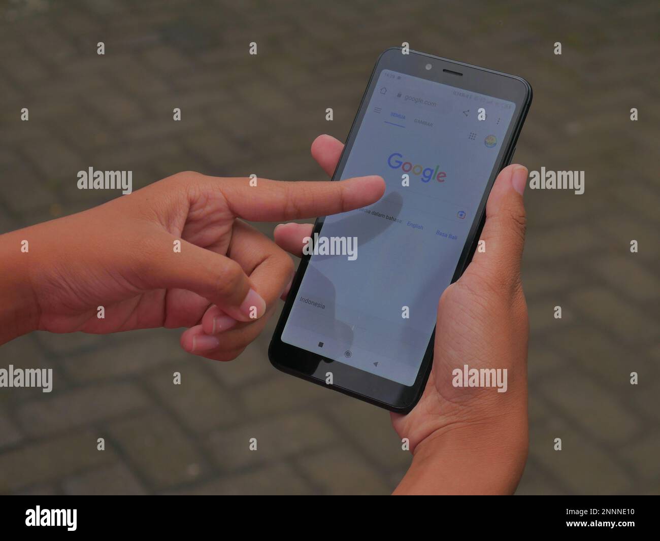 close up of hand holding smartphone opening google search engine Stock ...