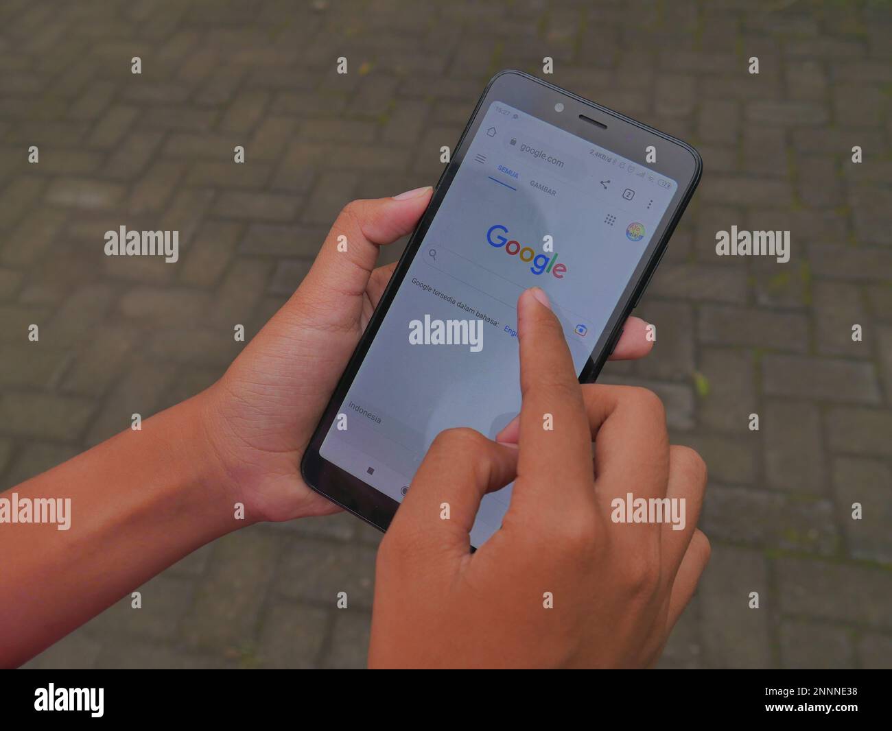 close up of hand holding smartphone opening google search engine Stock ...