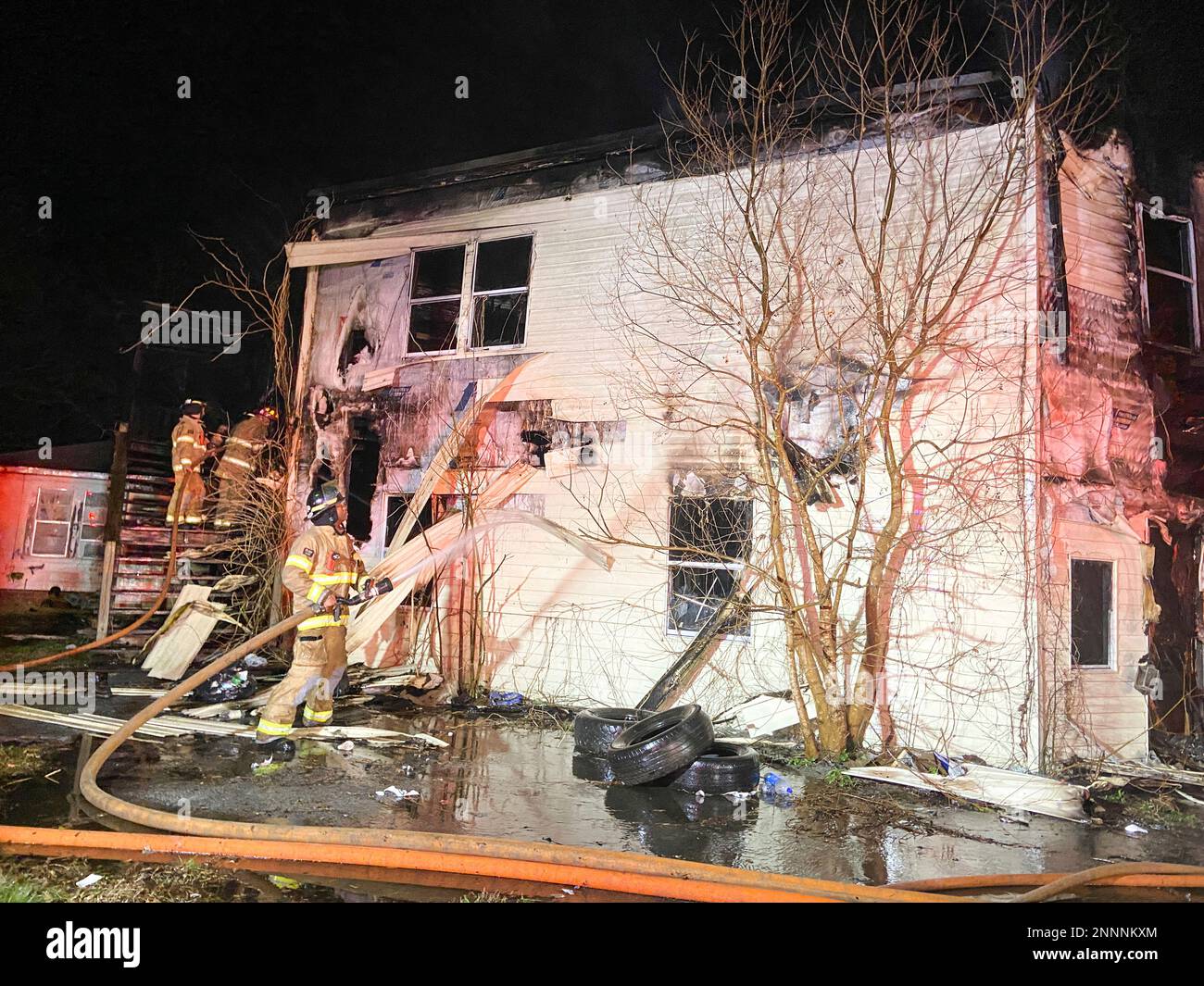 Firefighters work a fire at a wood structure on B Street and Mill ...