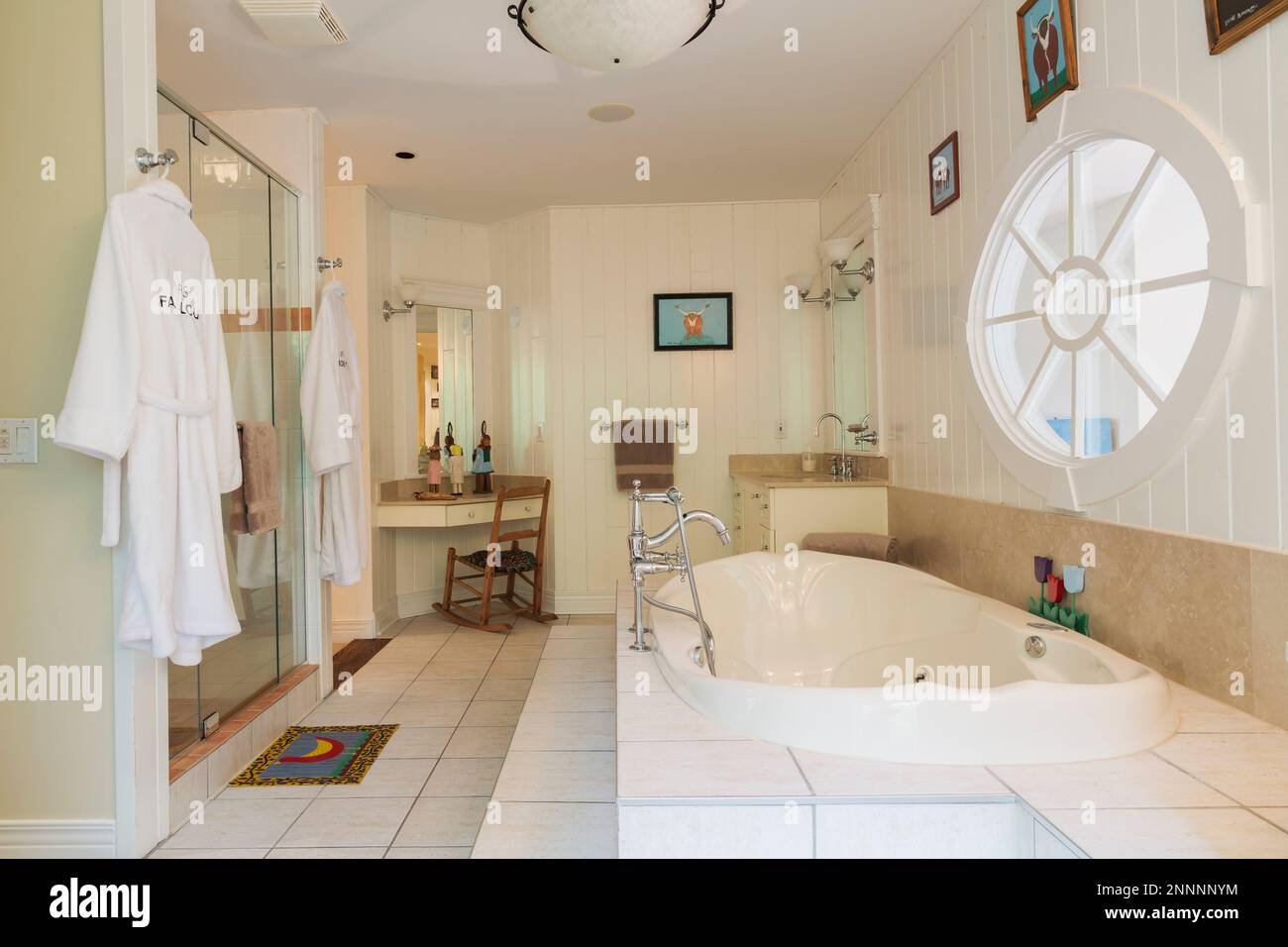 Elevated Jacuzzi bathtub encased in white ceramic base in en suite with ...