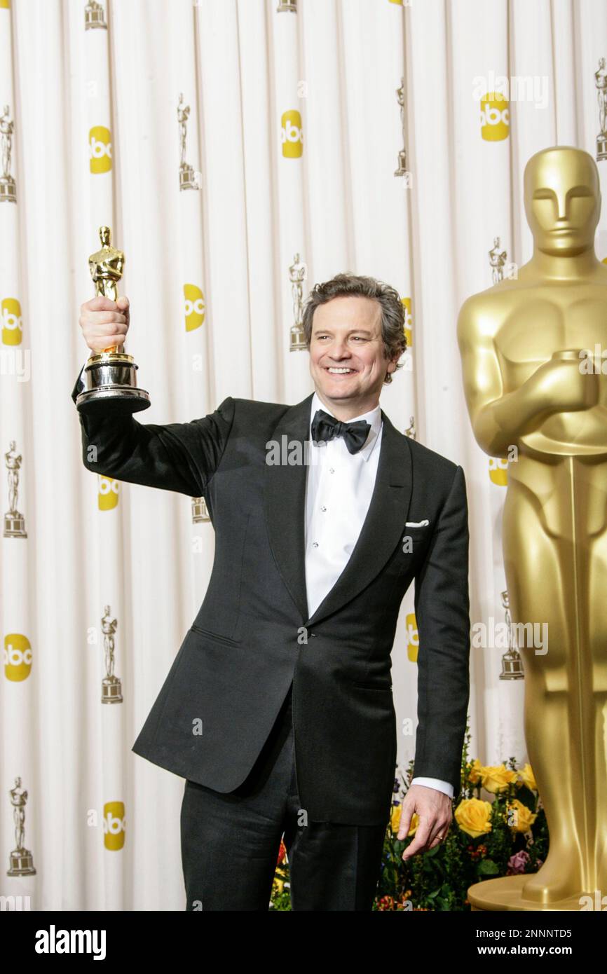 Actor Colin Firth holds the award for Best Actor in a Motion Picture ...