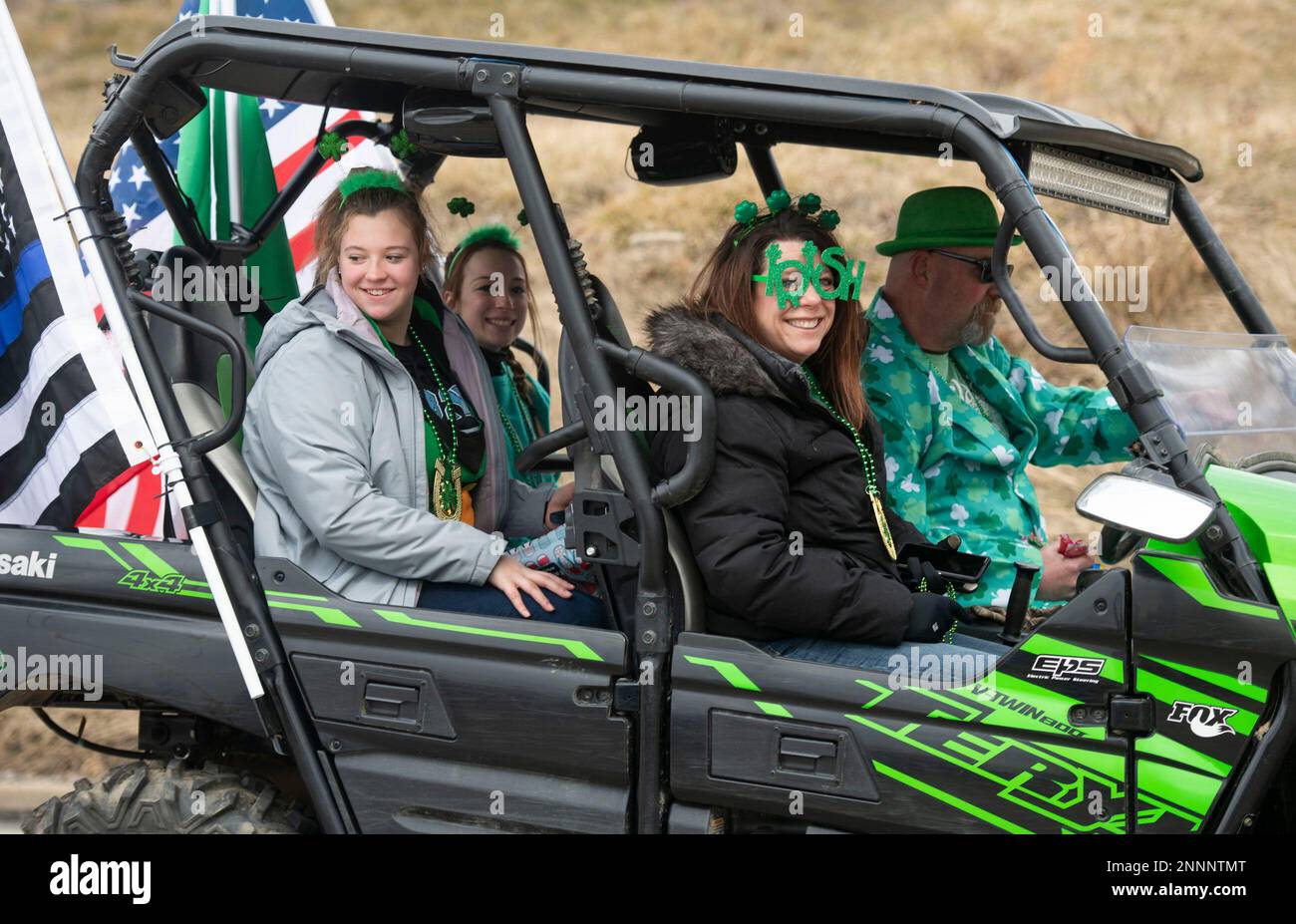 Parade participants dressed in St. Patrick's Day garb make their way ...