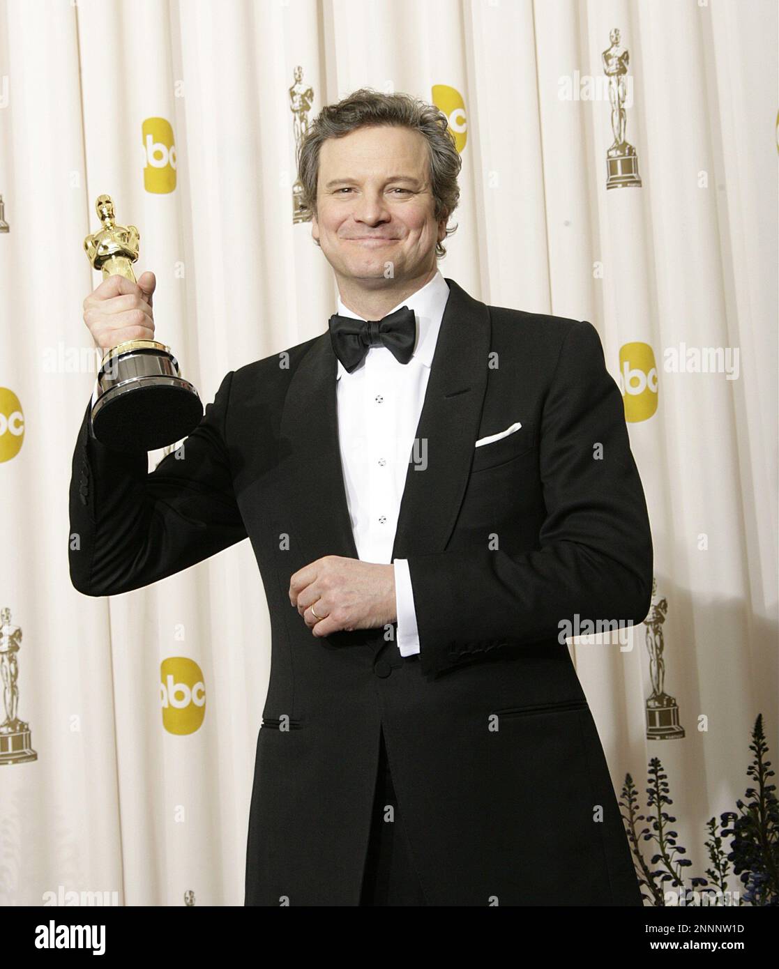 Actor Colin Firth holds the award for Best Actor in a Motion Picture ...