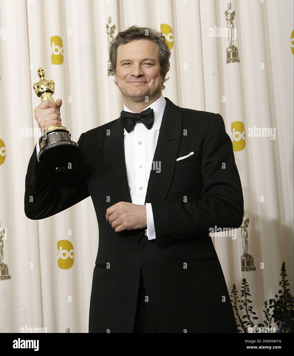 Actor Colin Firth holds the award for Best Actor in a Motion Picture ...