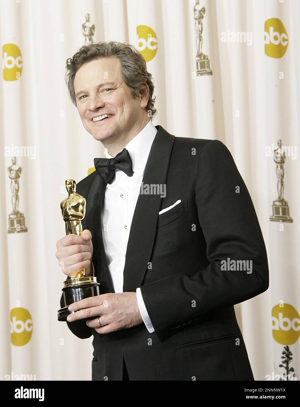 Actor Colin Firth holds the award for Best Actor in a Motion Picture ...