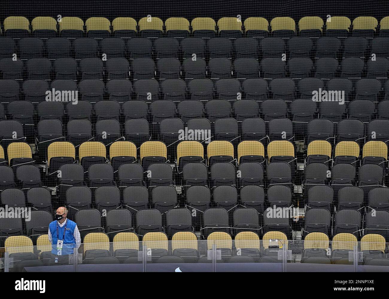 An usher watches over an empty section of seats during an NHL hockey ...