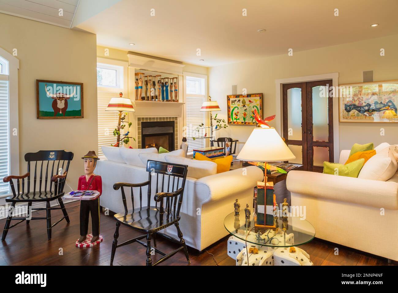 Black wooden armchairs, folk art pig table with glass top, Mountie ...