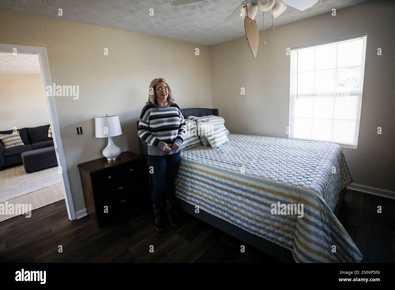 Carol Dean stands in the master bedroom of her new home on Wednesday ...