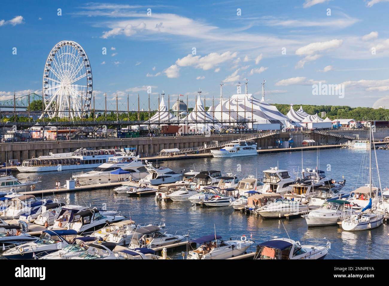 Moored private yachts in old port of Montreal marina and La Grande Roue ...