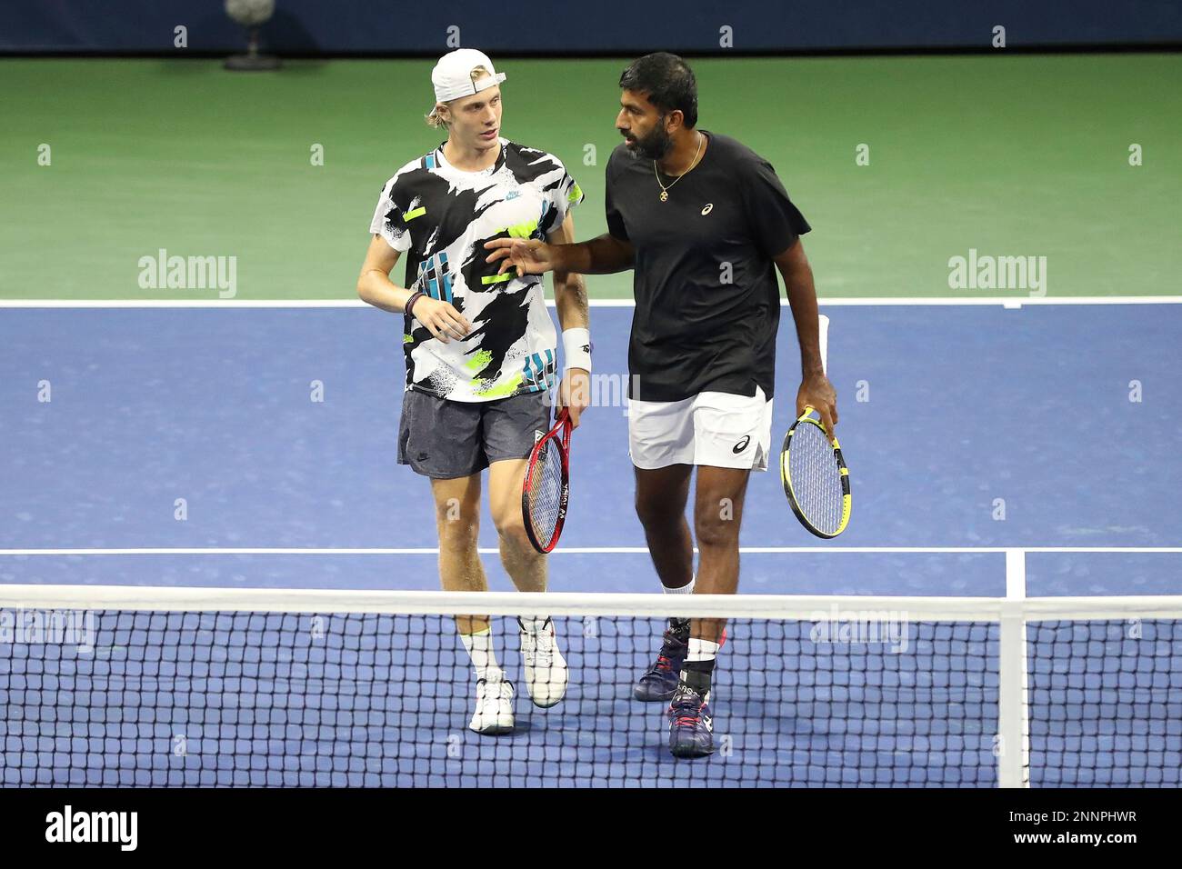 Rohan Bopanna and Denis Shapovalov in action against Ernesto Escobedo ...