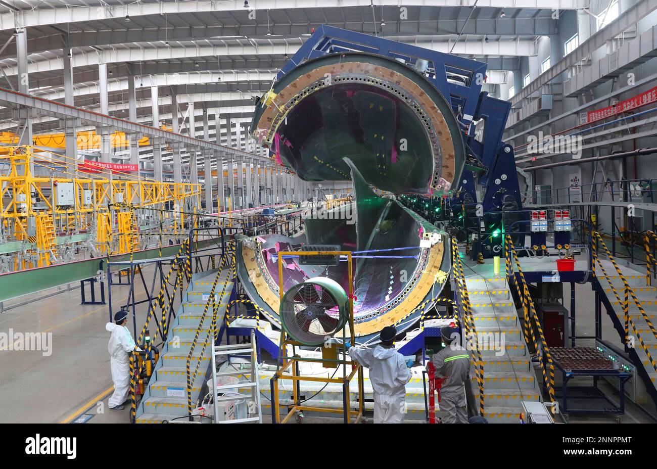 People work on the wind turbine blades at a factory in Haimen in east ...