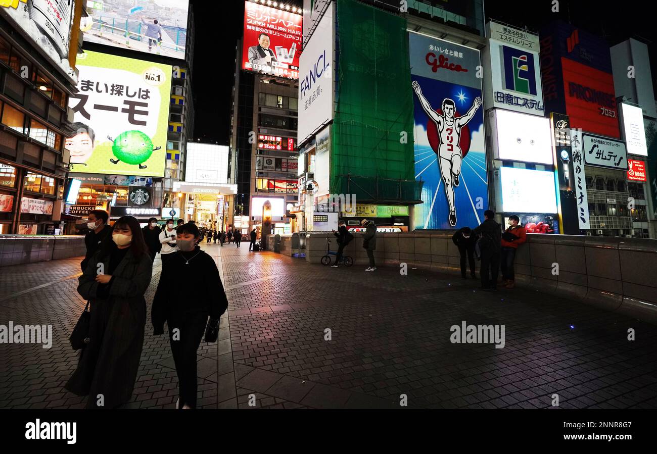 People wearing masks are seen at Minami district, a downtown areain ...