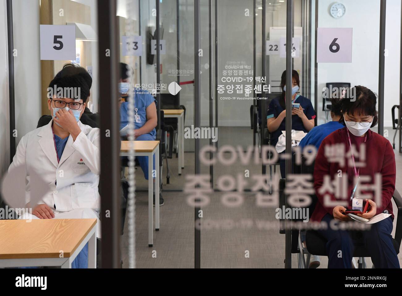 Medical workers wait to receive the first dose of the Pfizer BioNTech ...