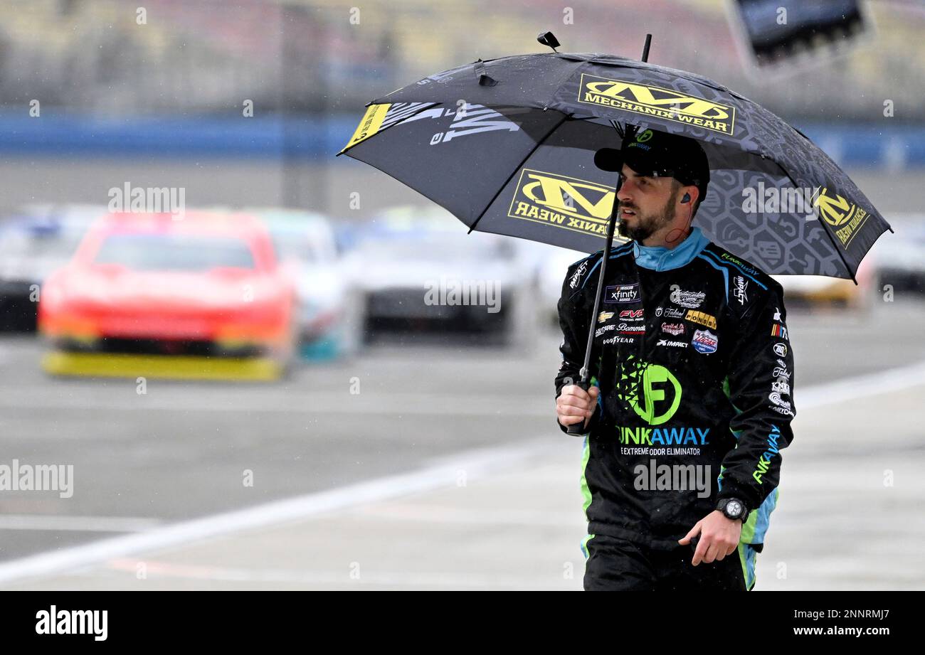 A NASCAR Xfinity Series crew member walks down the pit lane as race ...