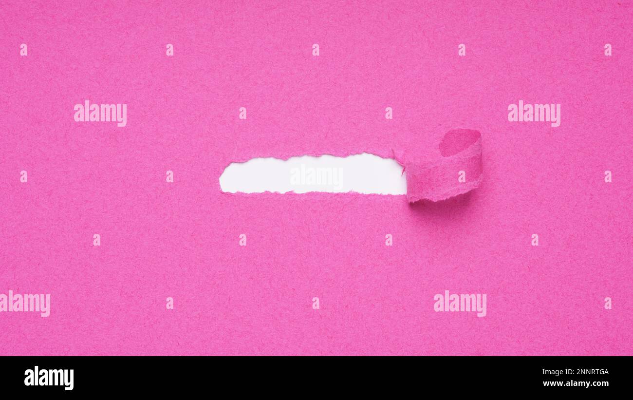 tearing off paper shred to reveal hidden copy space underneath - pink ...