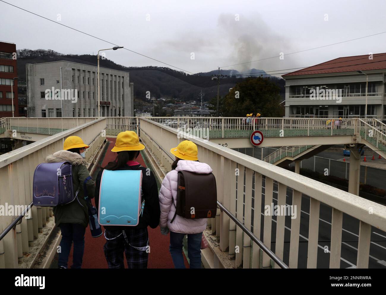 Elementary students go to school while a forest fire that continues to ...