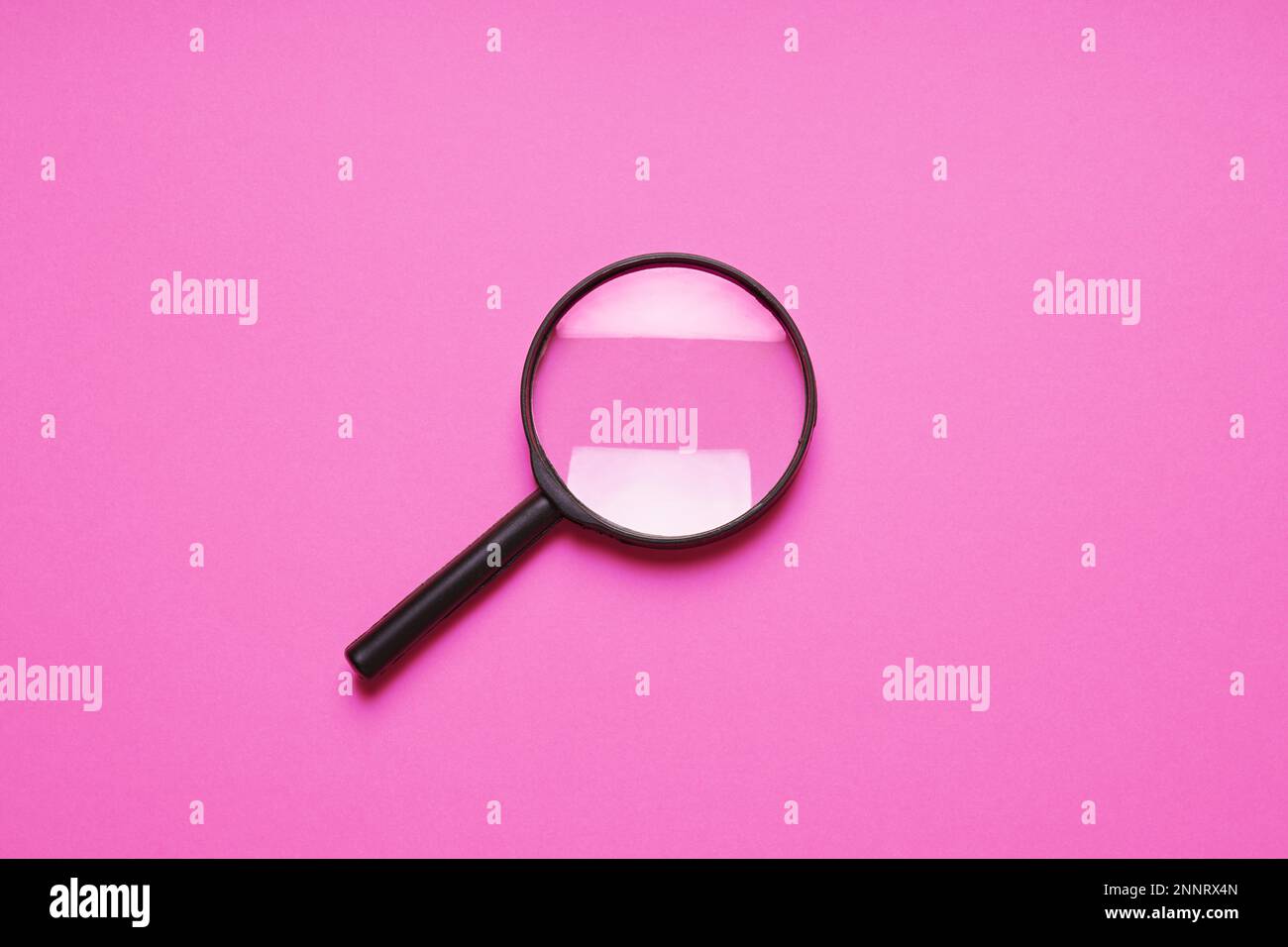 magnifying glass magnifier loupe search symbol on pink background with ...