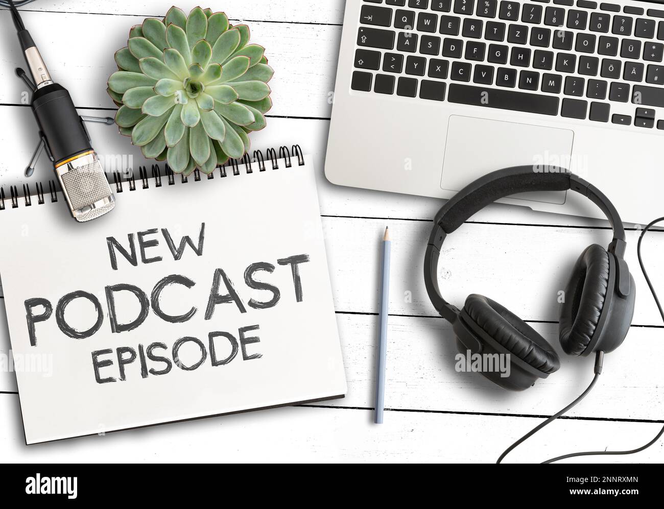 top view of text NEW PODCAST EPISODE on notepad with laptop computer ...