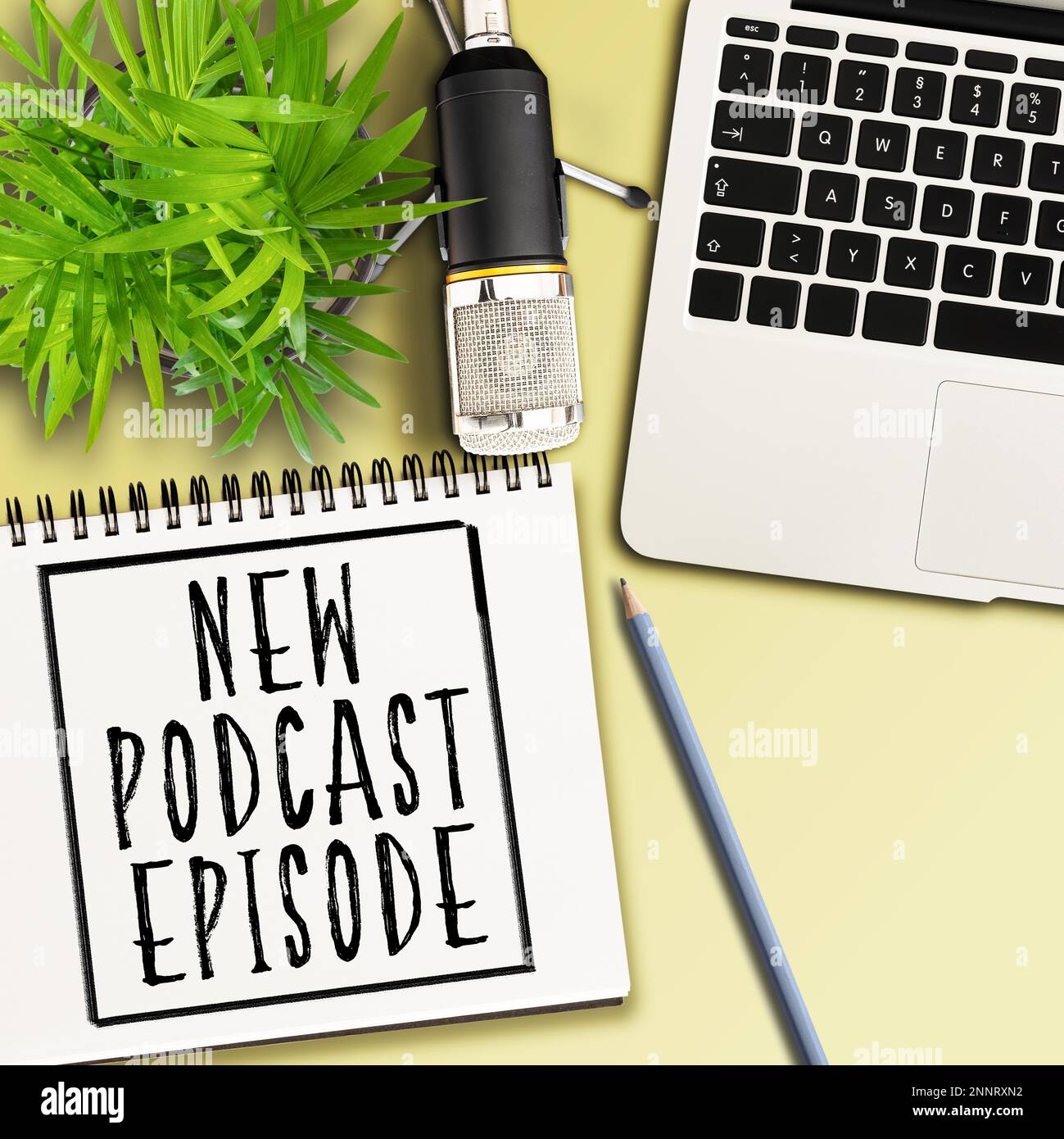 top view of words NEW PODCAST EPISODE written on spiral notepad on desk ...
