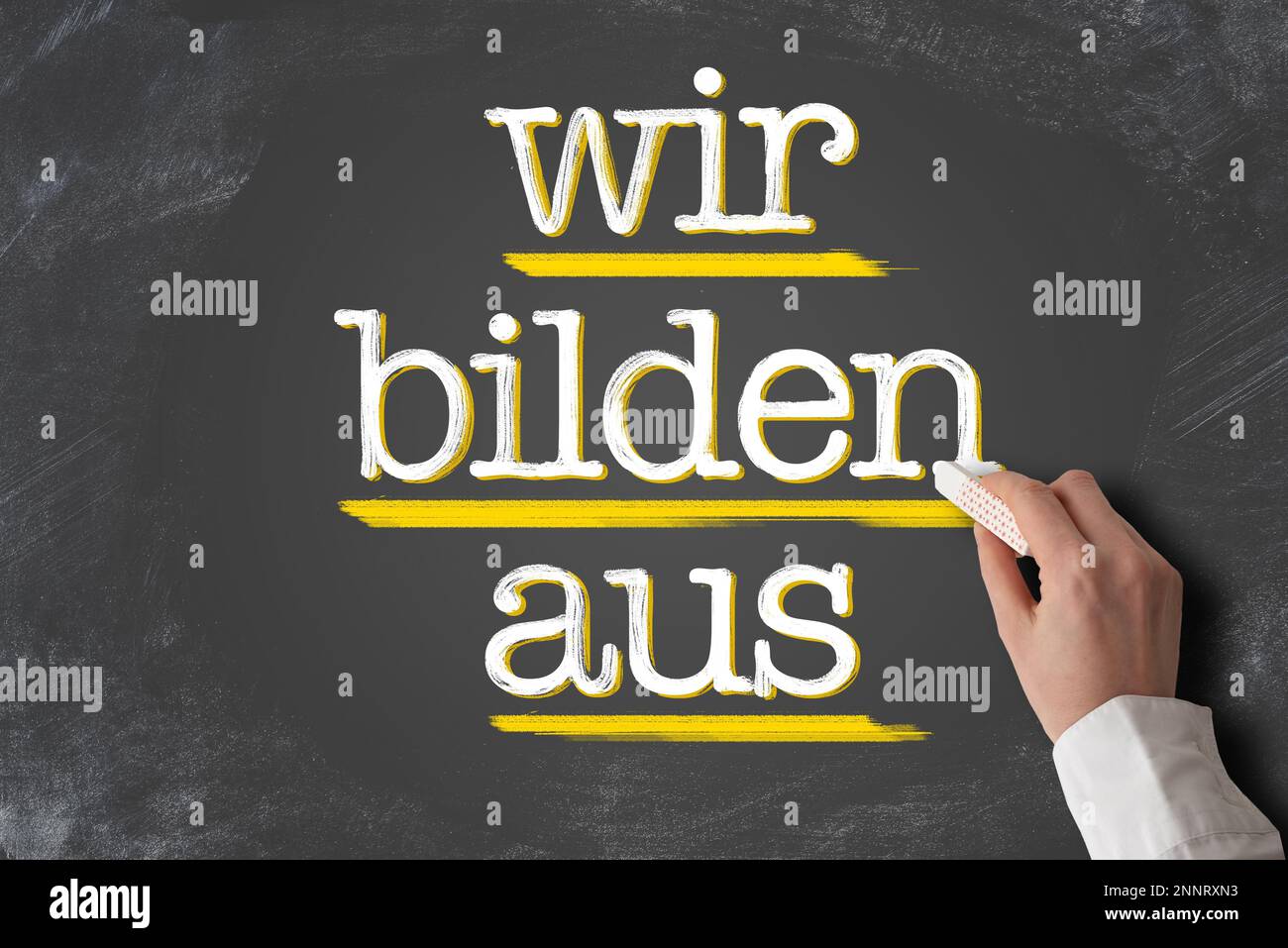 text WIR BILDEN AUS, German for we train apprentices, written on ...