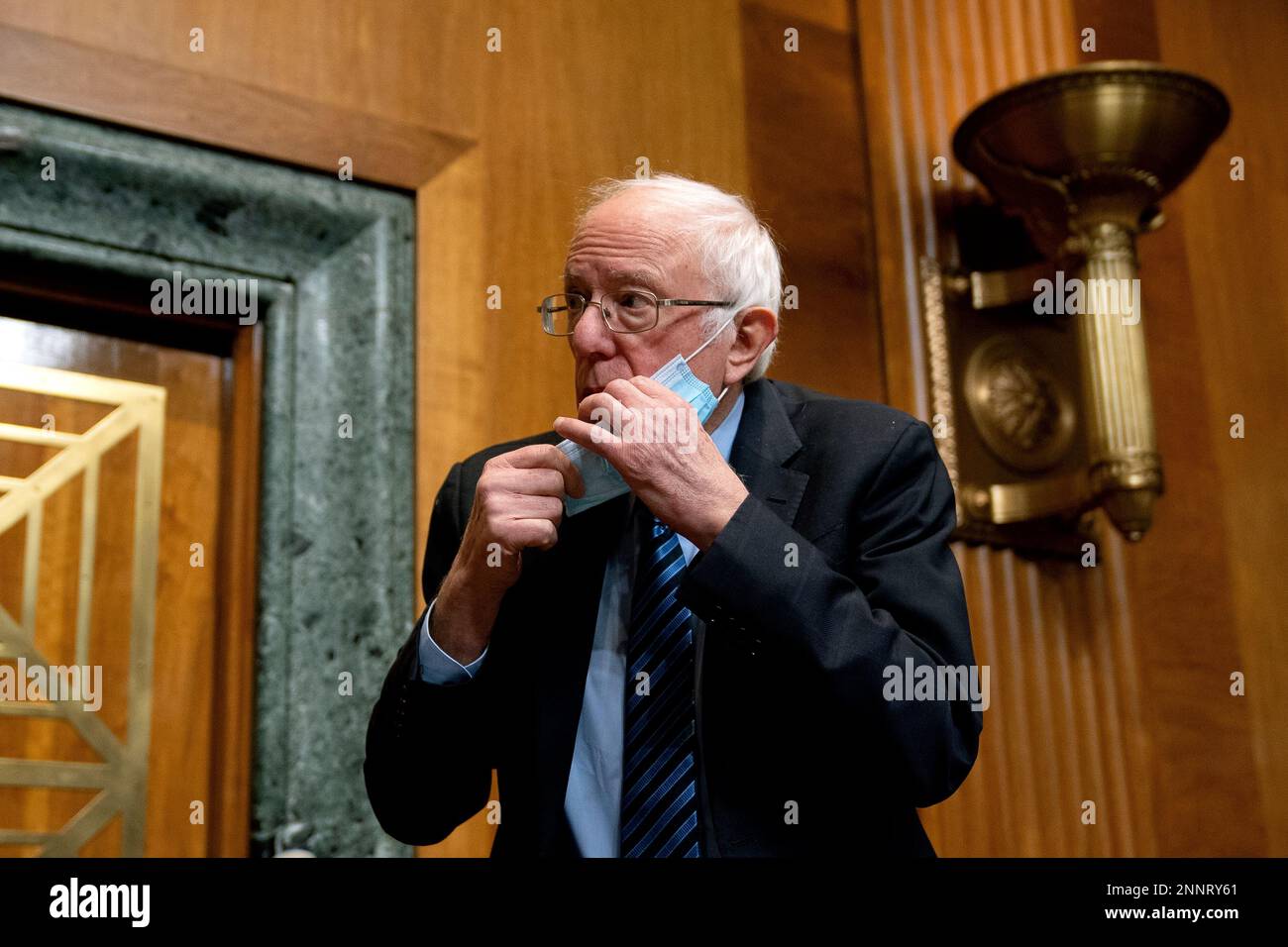 Sen. Bernie Sanders, I-Vt., Chairman of the Budget Committee, adjusts ...