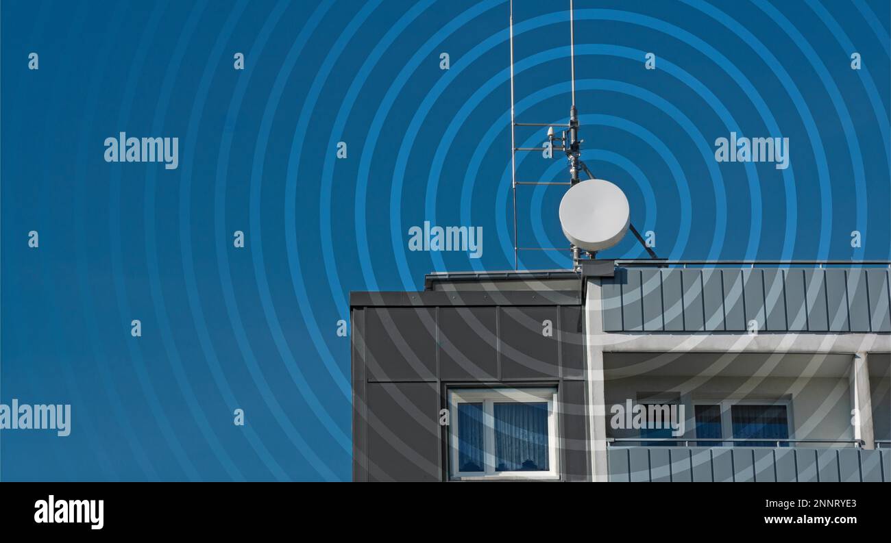 Transmission mast on roof of residential building with radio waves ...