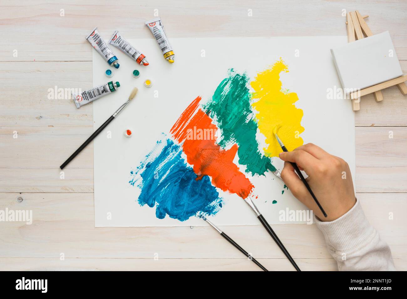 high angle view human hand painting white paper colorful brushstroke ...