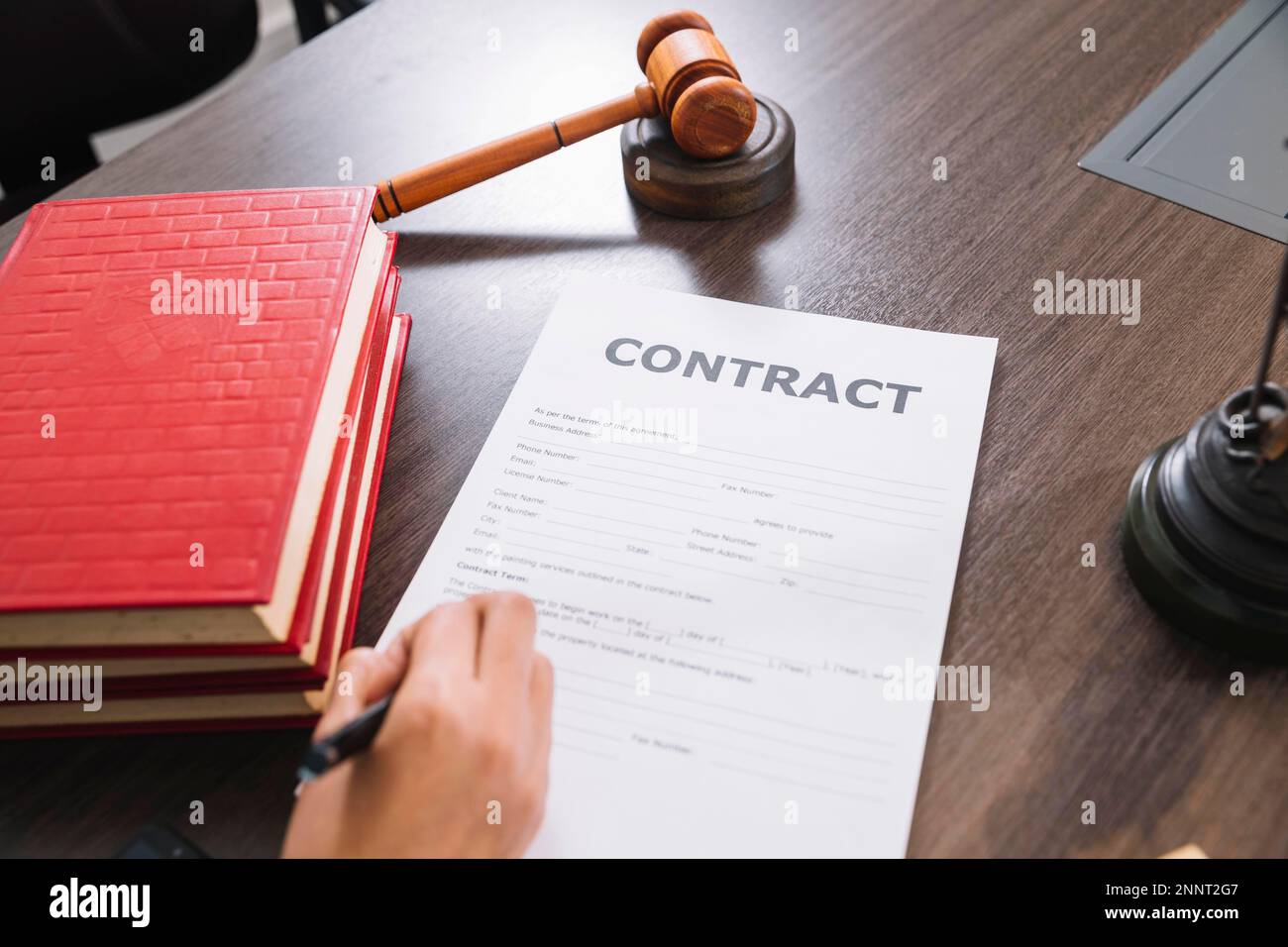 person writing document table with books gavel Stock Photo - Alamy