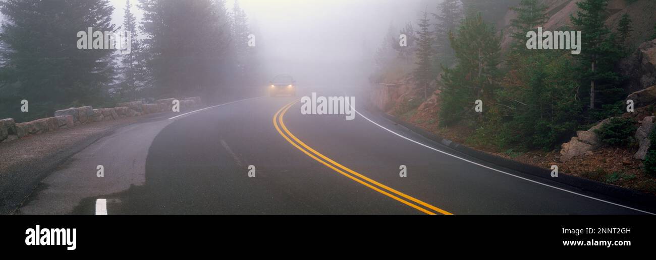 Car driving on road in fog, Trail Ridge Road, Rocky Mountain National ...