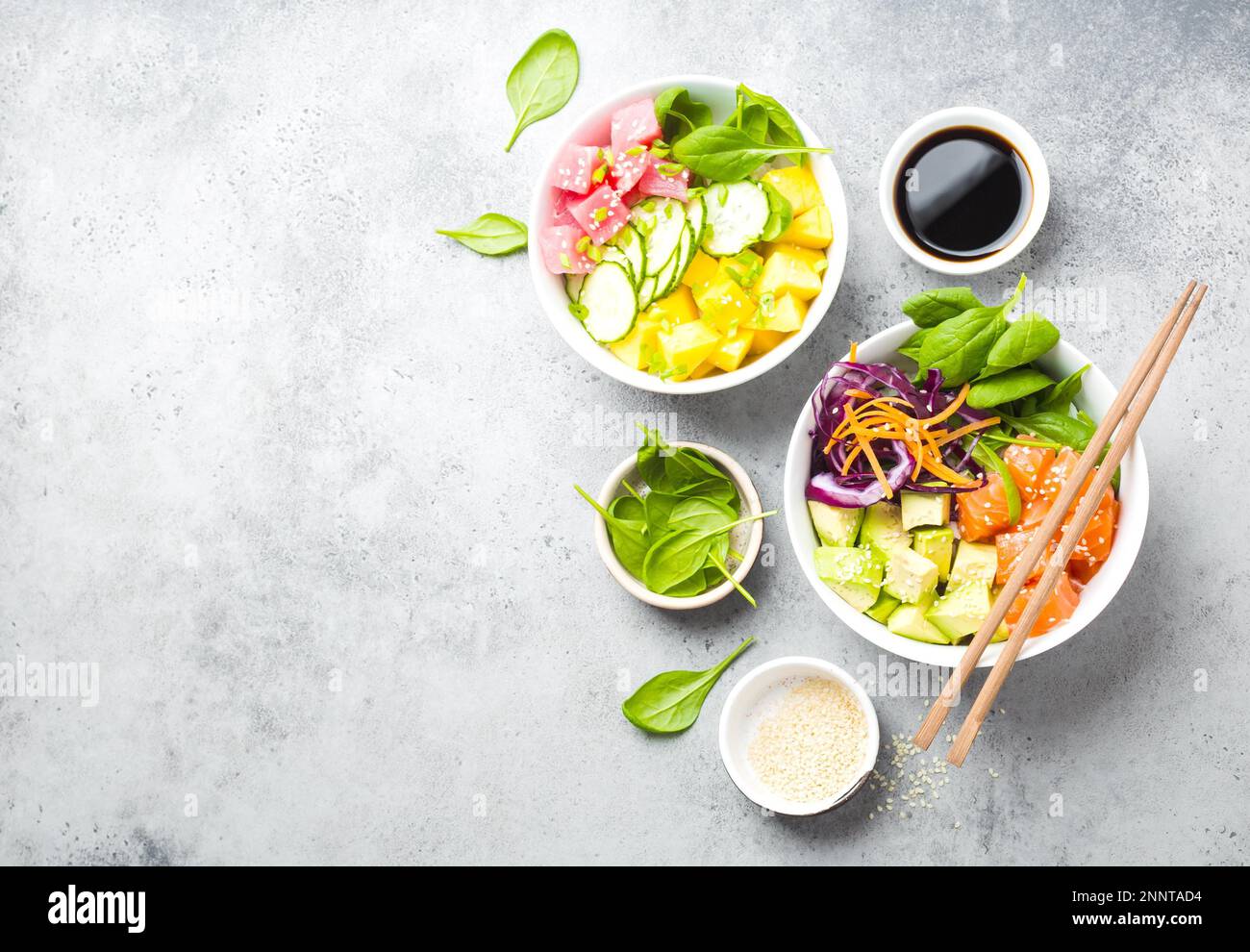 Two assorted poke bowls with raw fish and vegetables, space for text ...