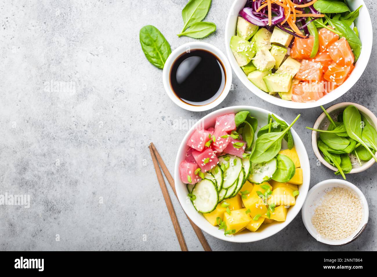 Two assorted poke bowls with raw fish and vegetables, space for text ...