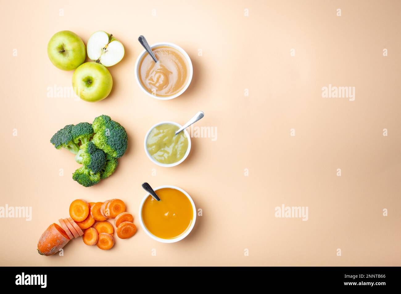 White bowls with healthy natural baby food on pastel background with ...