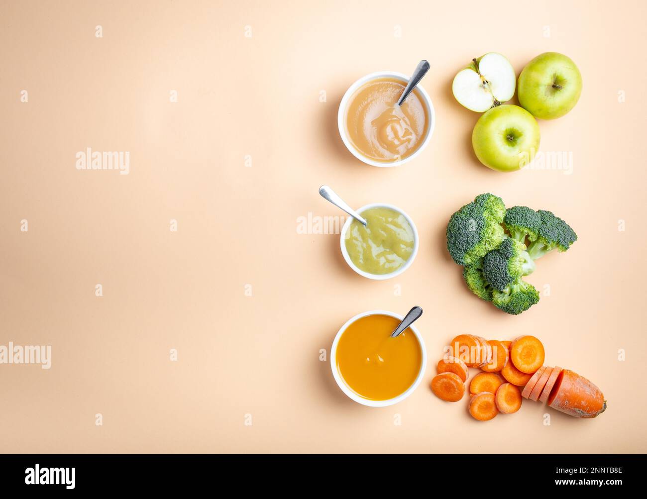 White bowls with healthy natural baby food on pastel background with ...