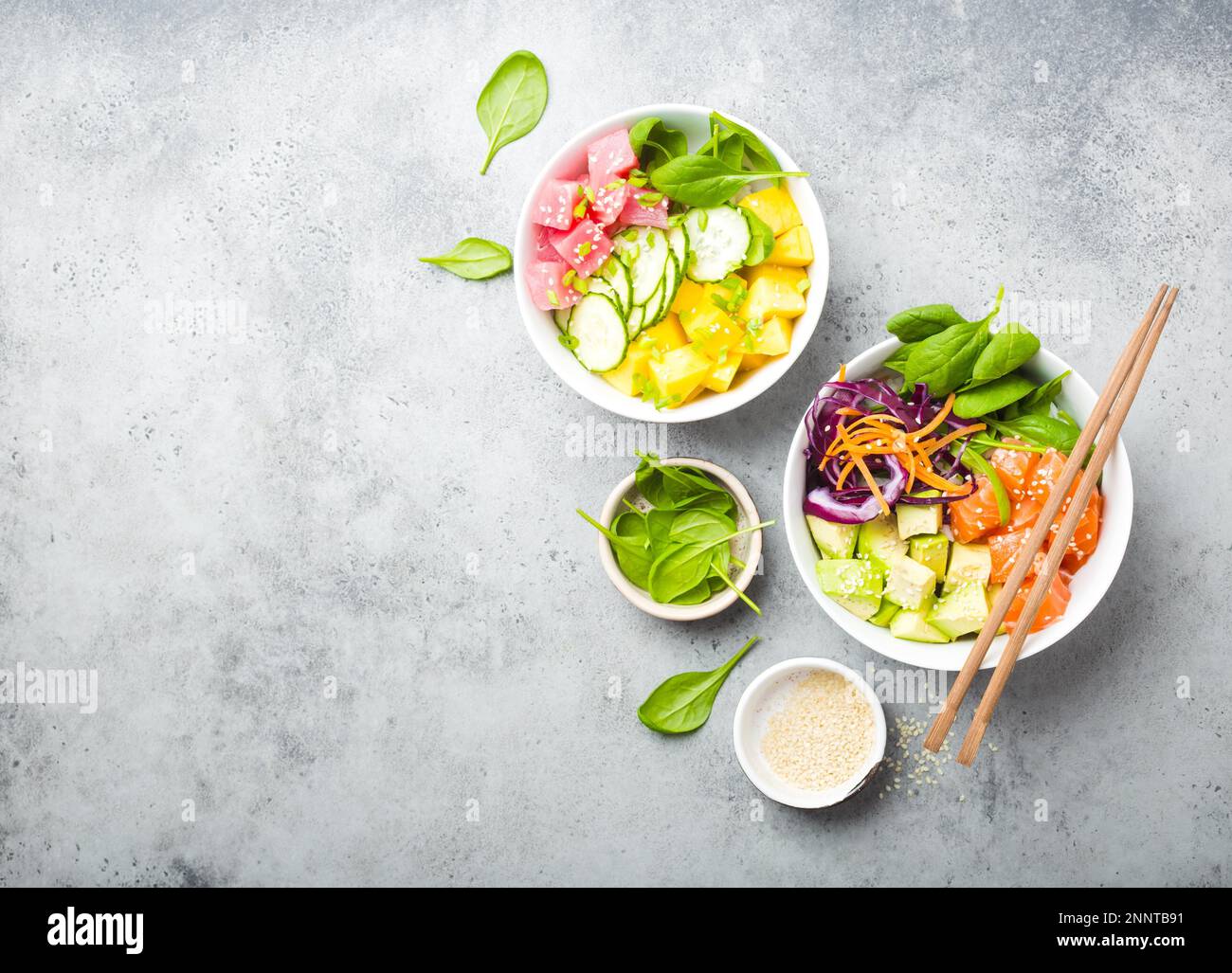 Two assorted poke bowls with raw fish and vegetables, space for text ...