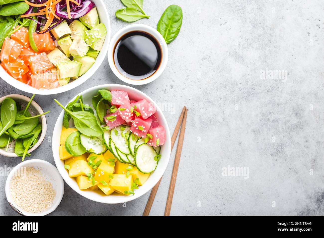 Two assorted poke bowls with raw fish and vegetables, space for text ...
